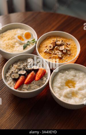 4 types of porridge in white bowls on a wooden background, oatmeal ...