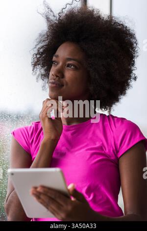 Beautiful african american woman using smartphone celebrating crazy and ...