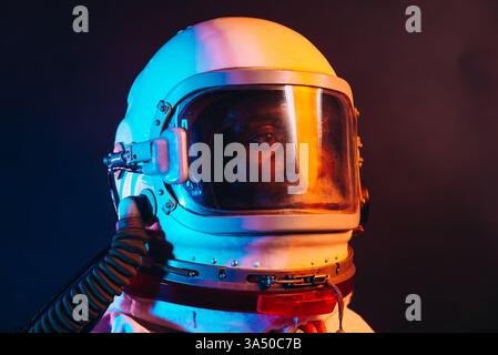 Serious African American male astronaut wearing space suit touching ...