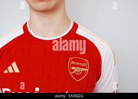 Photo of model wearing Arsenal FC home kit with club badge Stock Photo ...