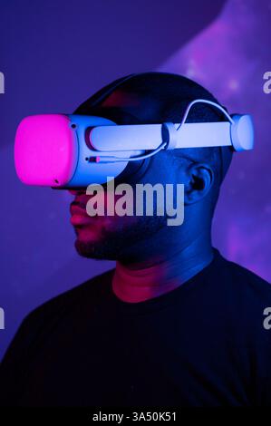 Serious Black man wearing VR headset experiencing virtual reality ...