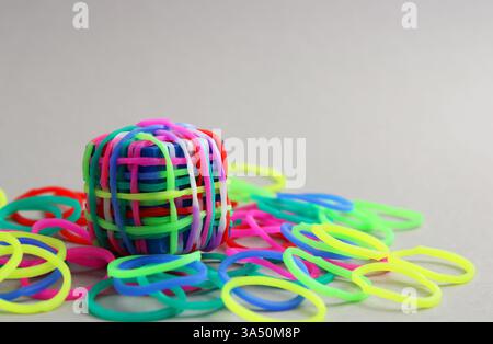Colorful rubber bands tied to a cube and a wooden star Stock Photo - Alamy