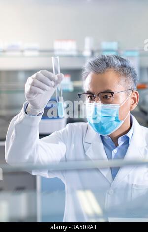 Chinese scientist examining medical sample in laboratory Stock Photo ...