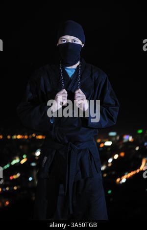 ninja assasin hold katana samurai old martial weapon swordat night with ...