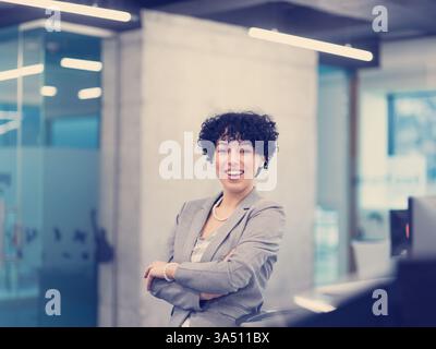Portrait of successful female software developer with a curly hairstyle ...