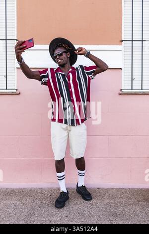 Photo of cheerful funky man wear denim shirt spectacles pointing empty ...