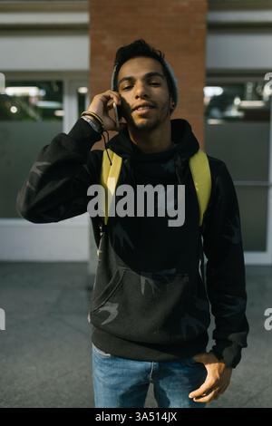 glad man speak on smartphone outdoor. man speak on smartphone outside ...