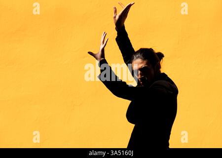 Young hispanic artist man with serious expression painting at art ...