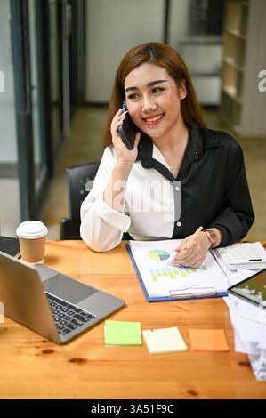 Beautiful millennial Asian businesswoman or female marketing manager ...