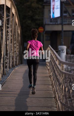 african american woman running across the bridge Stock Photo - Alamy