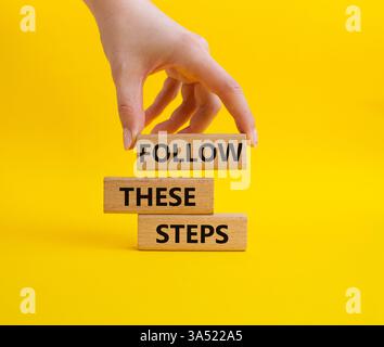 Follow these steps symbol. Wooden blocks with words Follow these steps ...