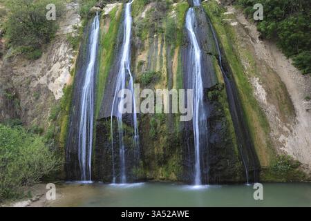 Unusual waterfall. Three parallel stream running down the steep slope ...
