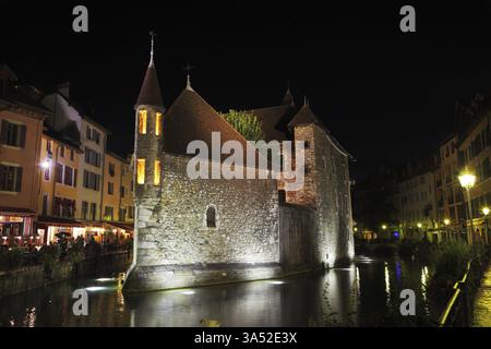 A gorgeous view of a city at night with a reflective pond in a park ...