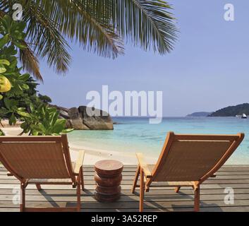 The green emerald sea with some yellow rocks Stock Photo - Alamy