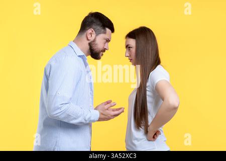 Angry couple arguing on yellow background. Relationship problem Stock ...