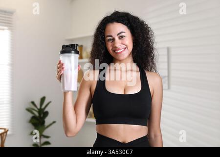 Beautiful young woman with protein shake outdoors Stock Photo - Alamy
