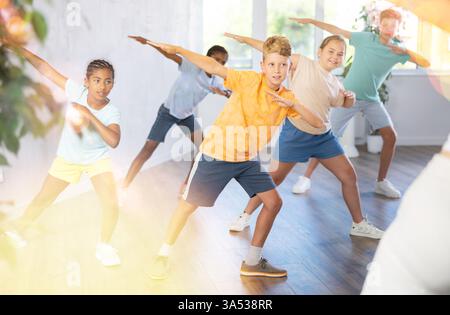 Active preteen children practicing Hip-hop dance in training hall Stock ...