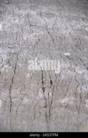 A detailed close-up of rugged mountain cliffs partially shrouded in ...