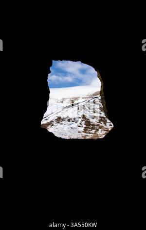 Cave on the rock. Entrance and windows of the cave. Beautiful view from ...