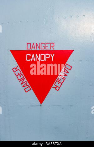 Red triangular warning sign displaying the words danger canopy ...