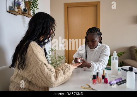 Hands during manicure care session Stock Photo - Alamy