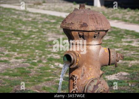 Water flowing out of an old fire hydrant Stock Photo - Alamy