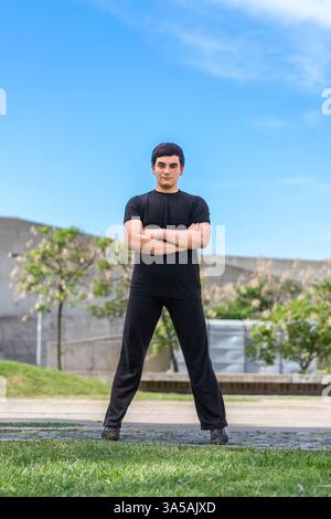 Man confidently looking at camera standing behind bar Stock Photo - Alamy