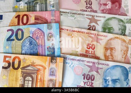 50 Turkish lira and 2 euro on black background. The worthlessness of ...