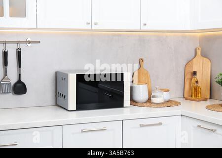 Closed microwave oven on counter in kitchen Stock Photo - Alamy