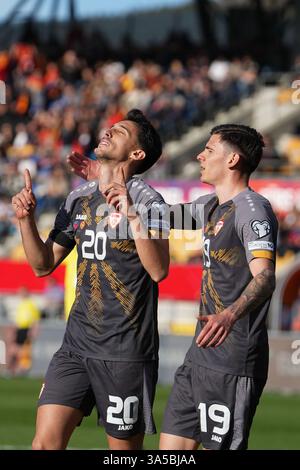 20, Bojan Miovski of North Macedonia plays the ball past 22, Josh ...