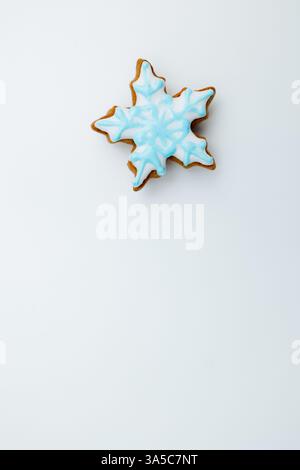 Tasty blue snowflake shaped cookie in snow decoration, traditional ...