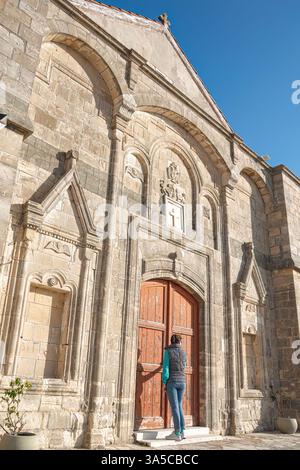tourist entering in the old church in the small village of Zona near at ...