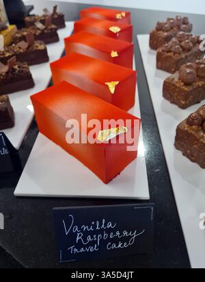 Creamy cakes in cafe showcase with price tag. Fresh pastry in cake ...