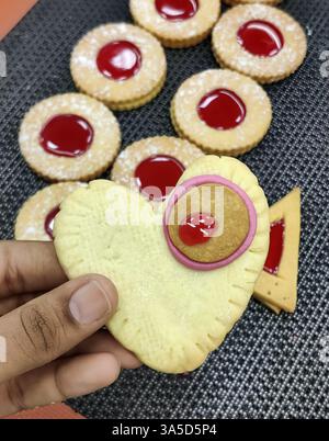 A closeup of a hand holding a round-shaped paper cut with german text ...