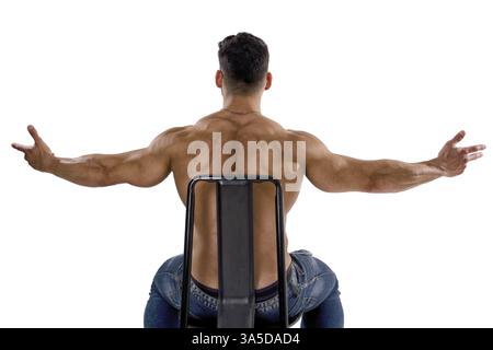 Male bodybuilder sitting on chair, seen from behind, unrecognizable man ...