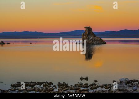 Magic sunset on the lake. Magnificent reflections of tuff outliers in ...