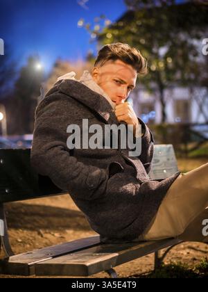 Handsome man wearing winter coat showing arms muscles smiling proud ...