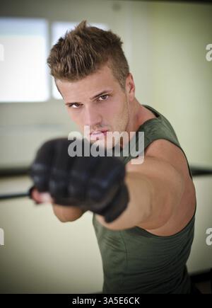 Adult male throwing a punch towards the camera giving the impression ...