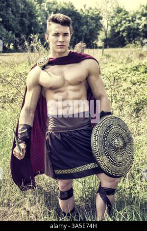 Young handsome muscular man posing in roman or spartan gladiator ...
