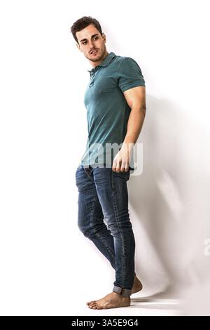 Young man in green shirt hold lotto sphere spins small balls, table ...