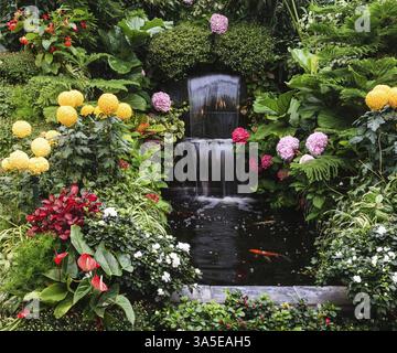 A beautiful view of an empty fountain surrounded by green trees in a ...