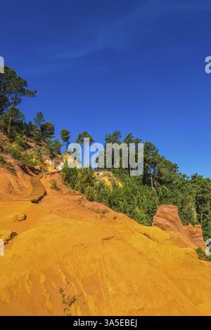 Steps for tourists on a steep slope. Unique red and orange hills in the ...