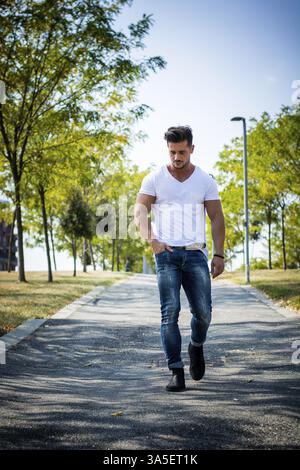 Full length photo of attractive man in striped t-shirt smiling and ...