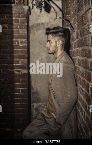 Profile side photo of young guy sit violet armchair celebrate victory ...