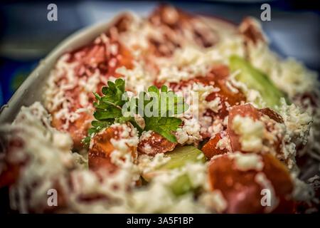 Tasty Shopska or sopska salata with vegetables and cheese closeup in ...