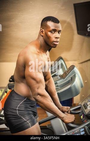 Hunky muscular black male bodybuilder exercising and jogging on ...