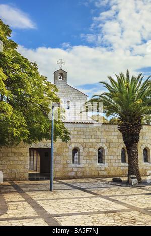 Small cozy church yard on the Sea of Galilee, Israel. Round bed with ...