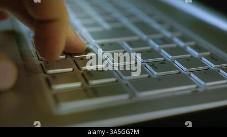 User authentication close-up of a hand typing a hidden password on a ...