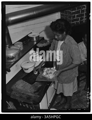 Mrs. James Robert Howard prepares supper in their home, while her ...