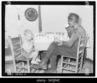 Rufus Sergent, a miner, and his son take a break to eat after a day’s ...